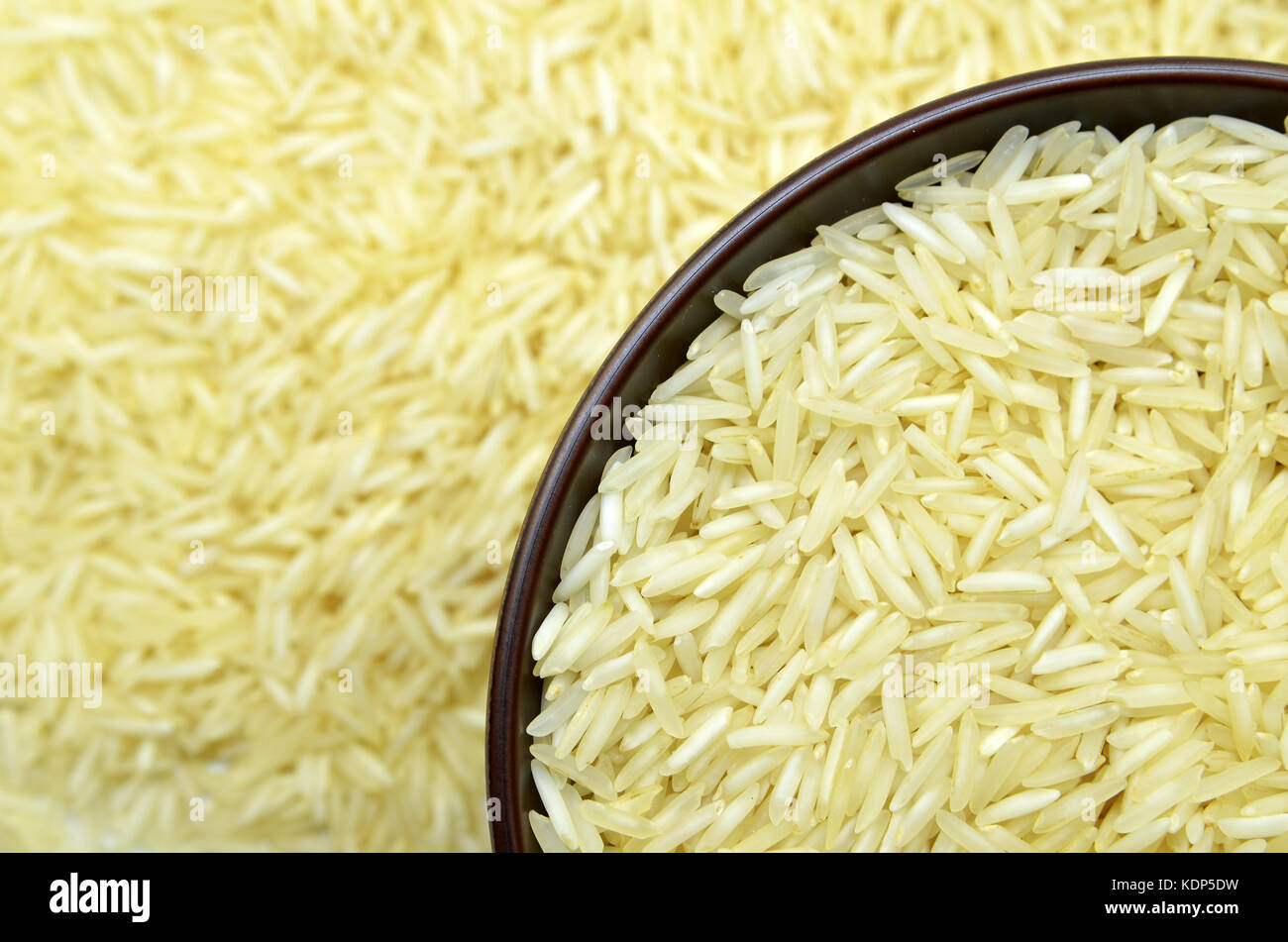 White basmati rice with wooden bowl. Close up Stock Photo - Alamy