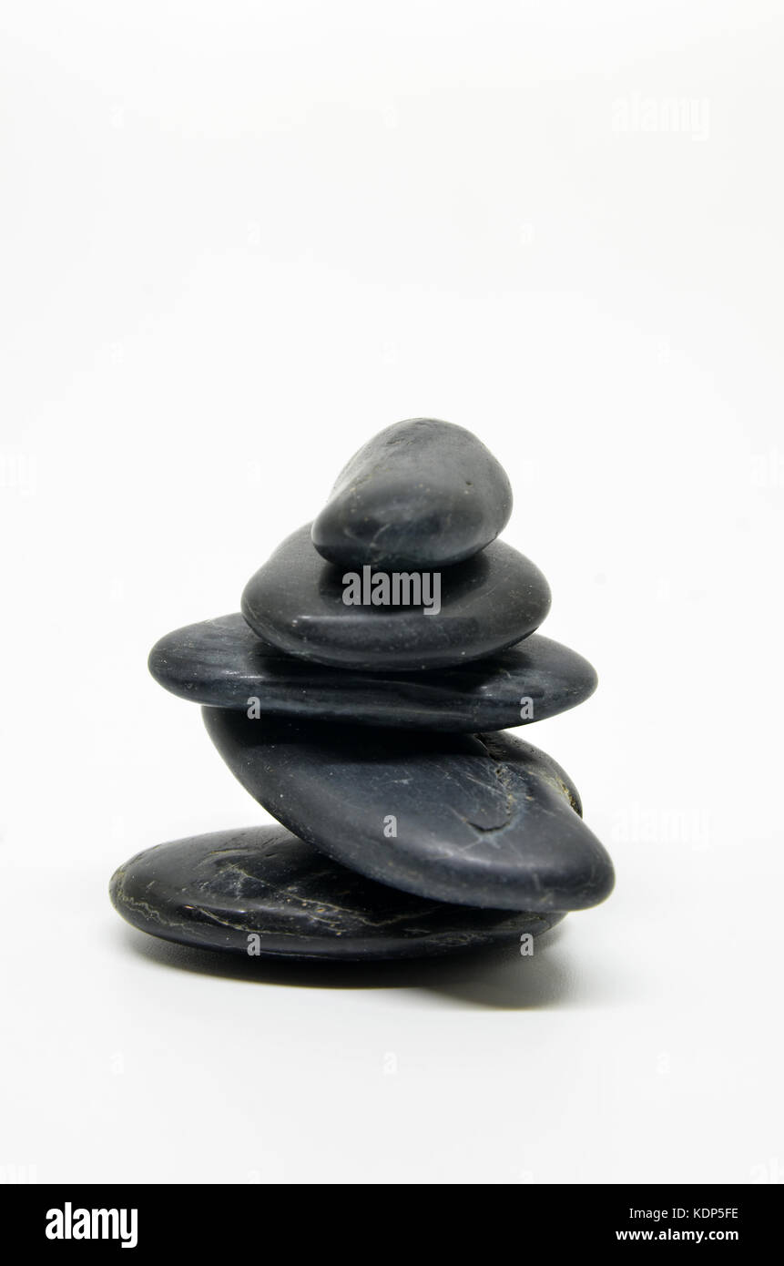Five black stones balanced isolated over white background Stock Photo ...