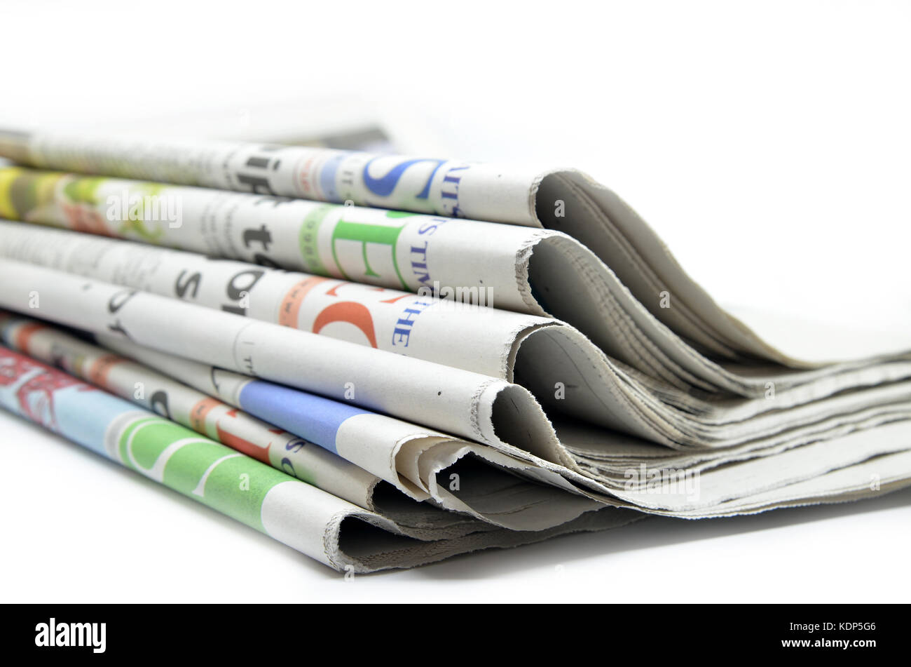 Newspapers folded and stacked isolated on white Stock Photo - Alamy