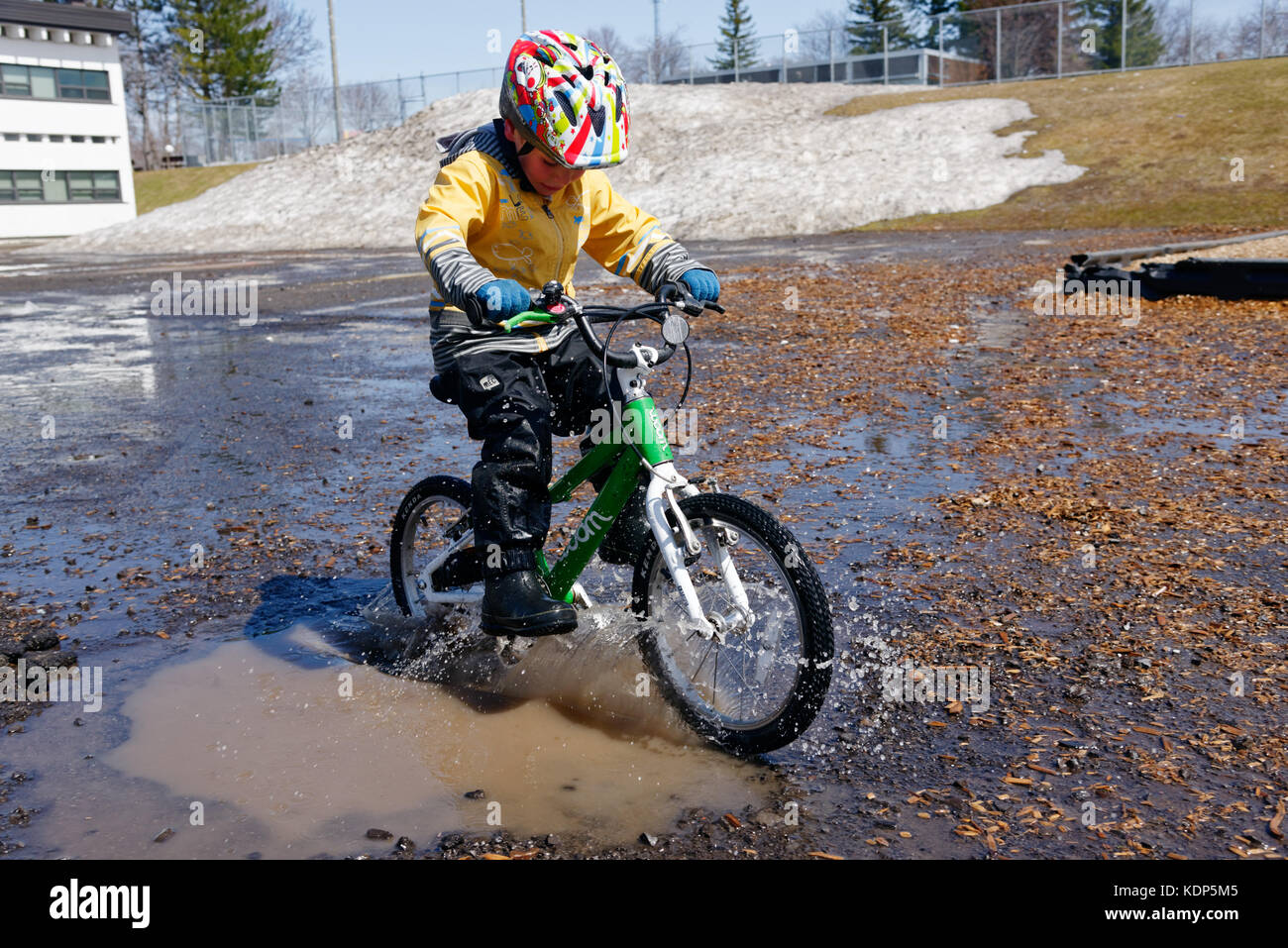 Child splashing through a puddle hi-res stock photography and images ...