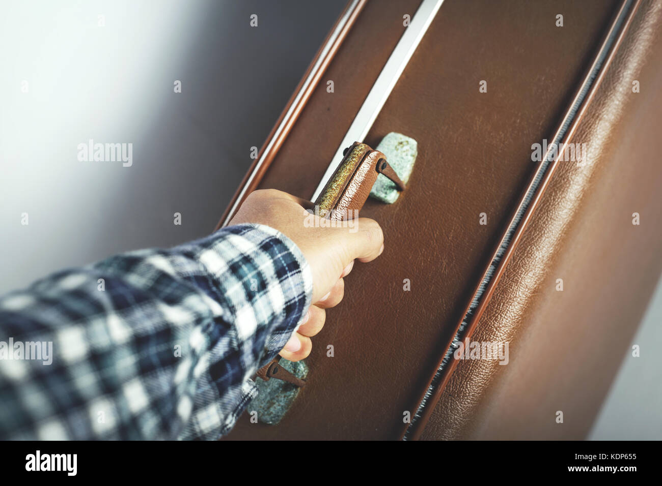 Hand holding suitcase Stock Photo - Alamy
