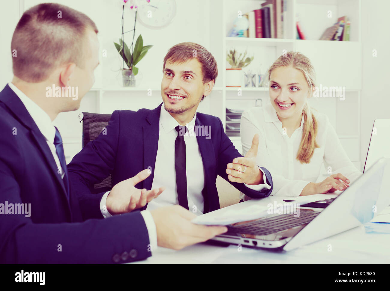 Glad business male and female assistants in formalwear having a ...