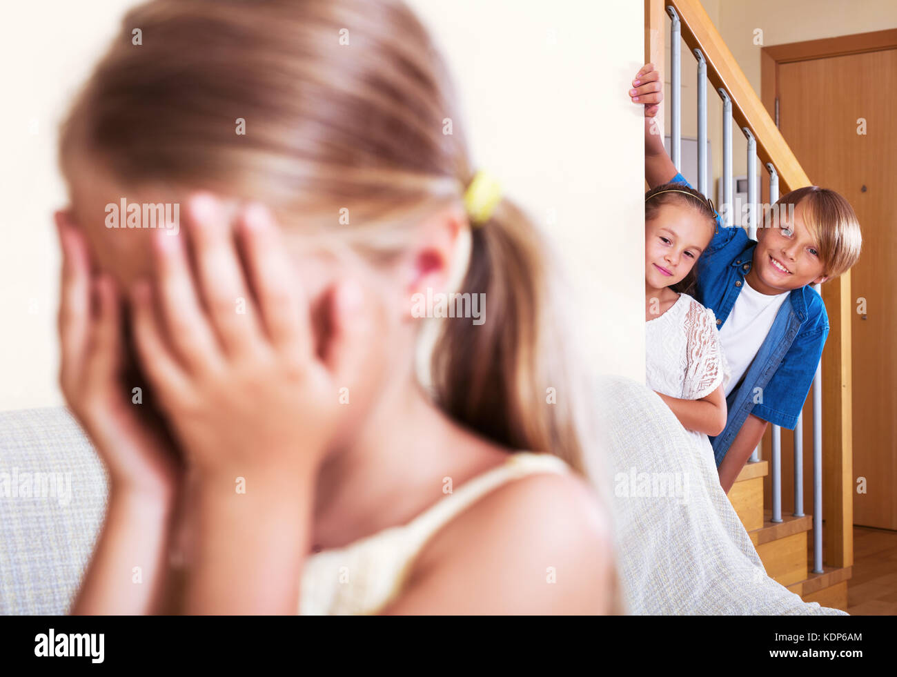 Happy children hiding from girl with closed eyes during game Stock ...