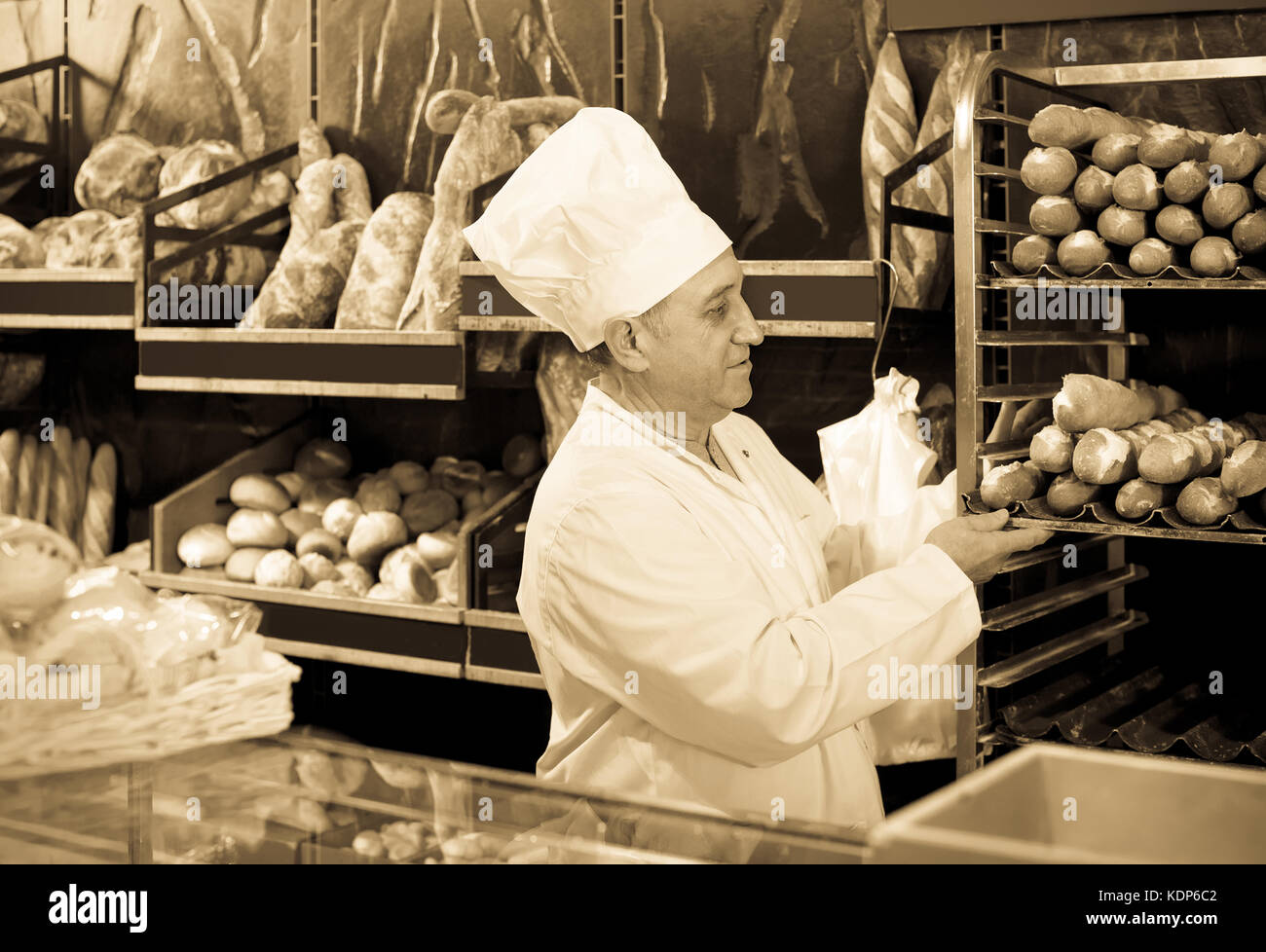Portrait of positive baker with fresh bread smiling in bakery Stock ...