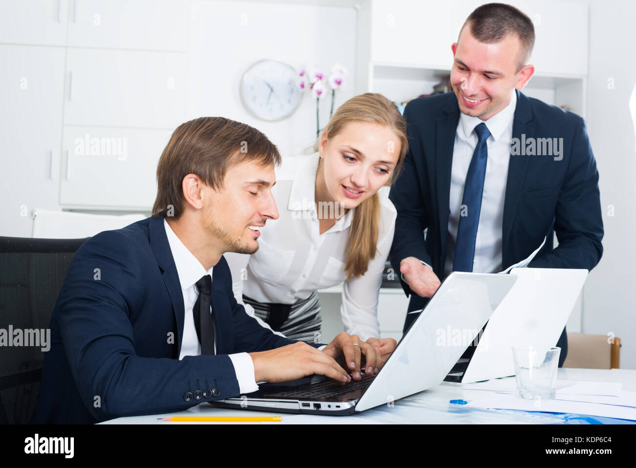 Three enthusiastic coworkers different sexes working on computers ...