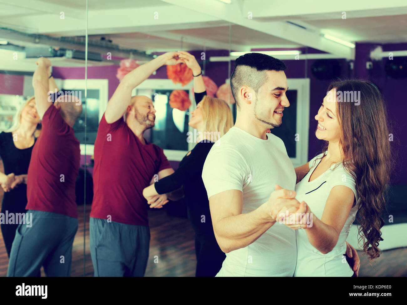 Happy young healthy people having dancing class indoors Stock Photo - Alamy