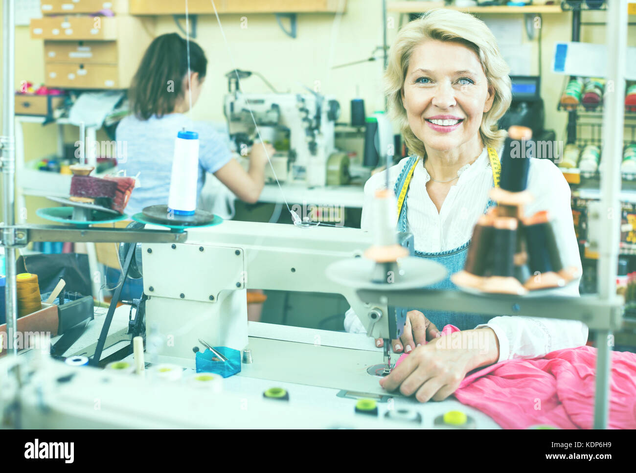 Portrait of two professional experienced female tailors working at the ...