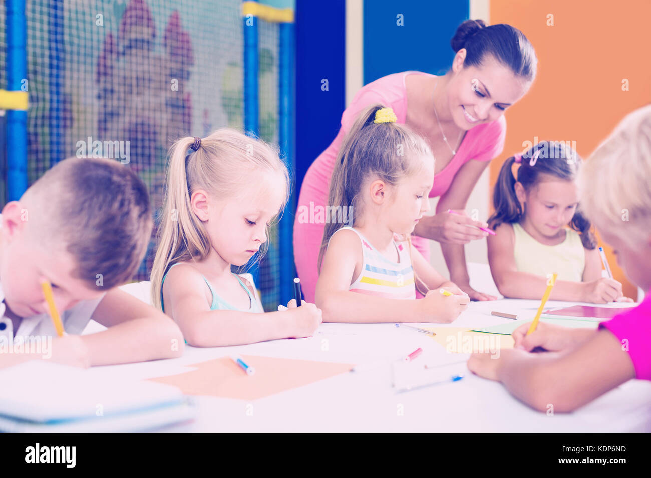 happy russian children sitting together and drawing in class at school ...