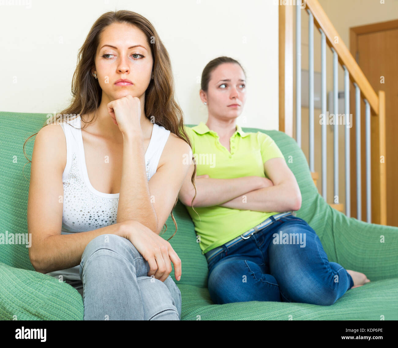 Two young beautiful women angry with each other at home Stock Photo - Alamy