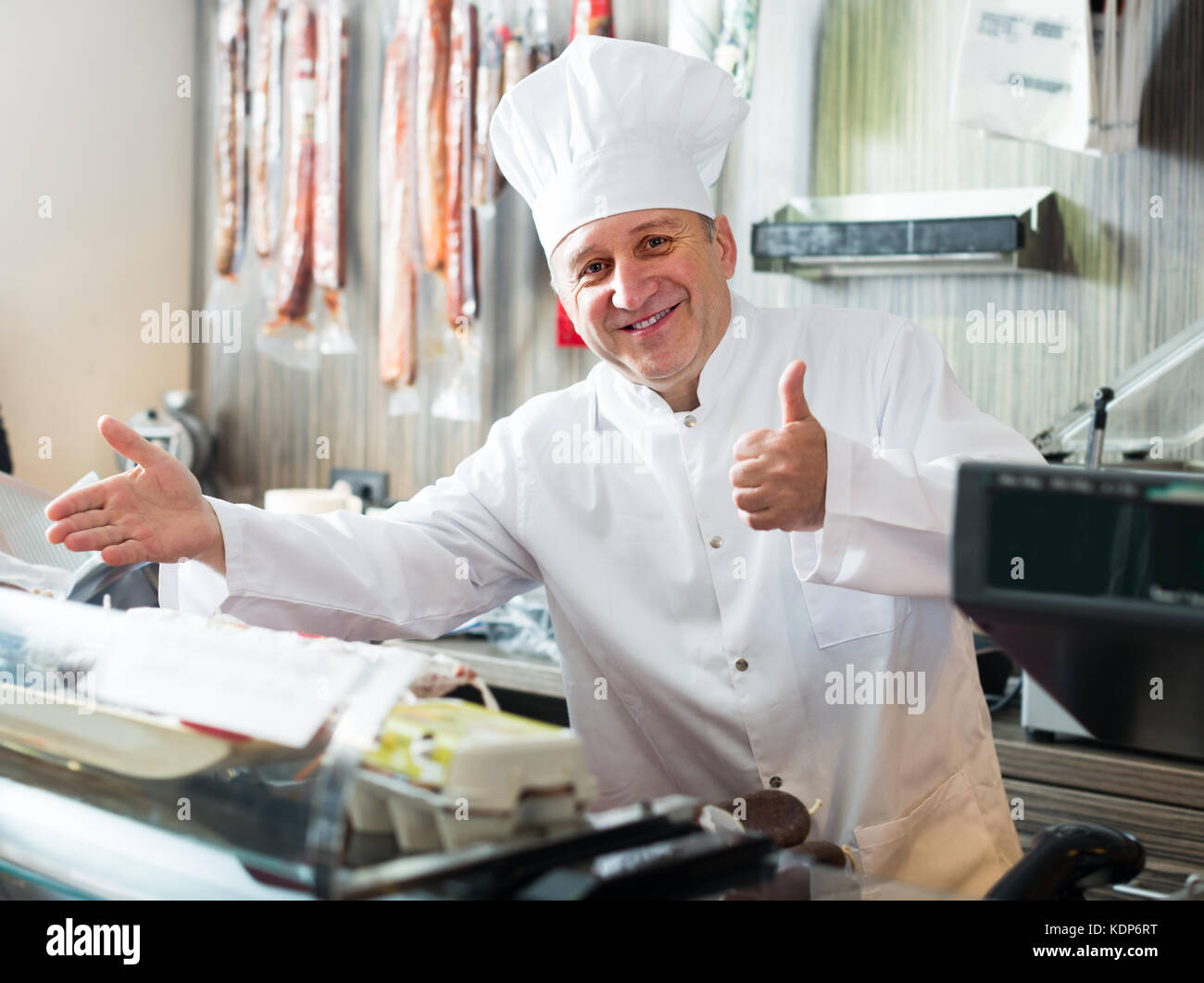 american male butcher with wurst and smoked meat at counter Stock Photo ...