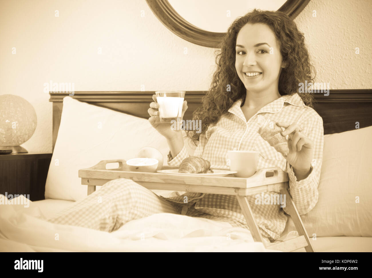 Brunette girl having healthy breakfast in bed at home Stock Photo - Alamy