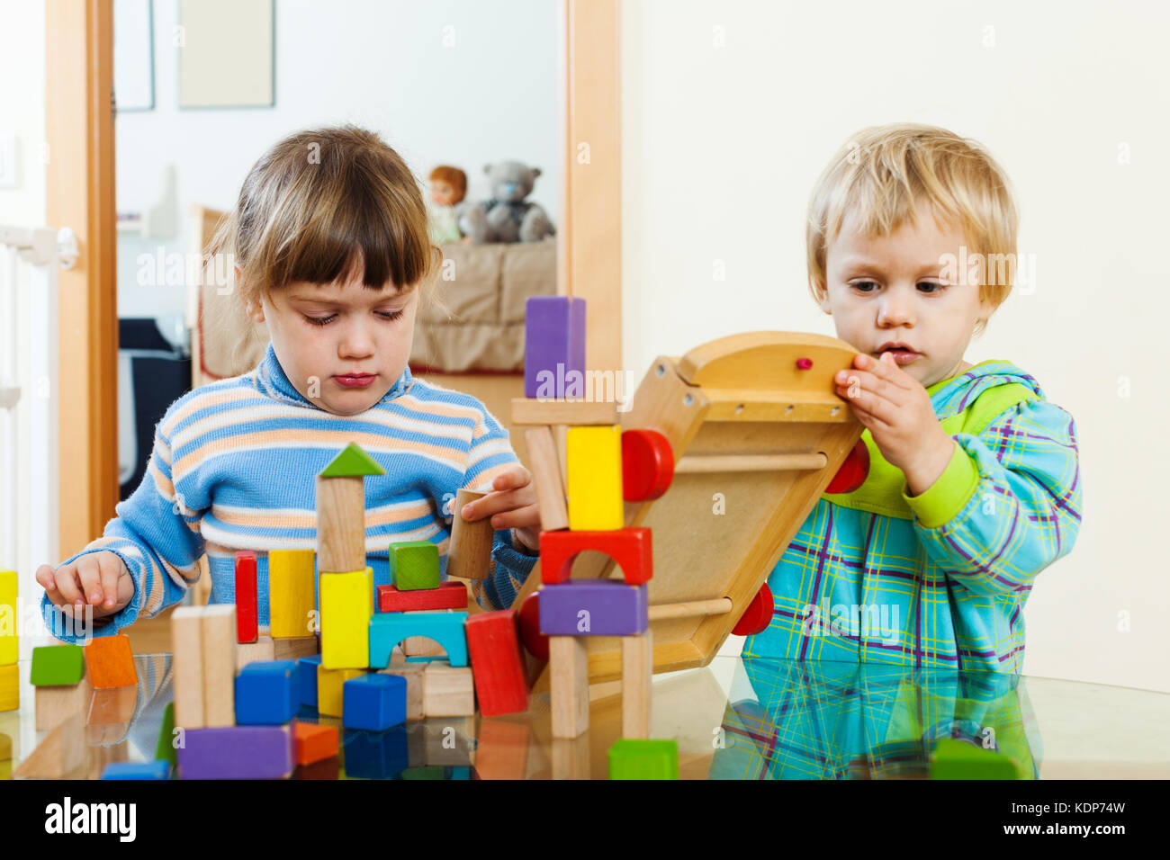 calm children playing with wooden blocks in home interior Stock Photo ...