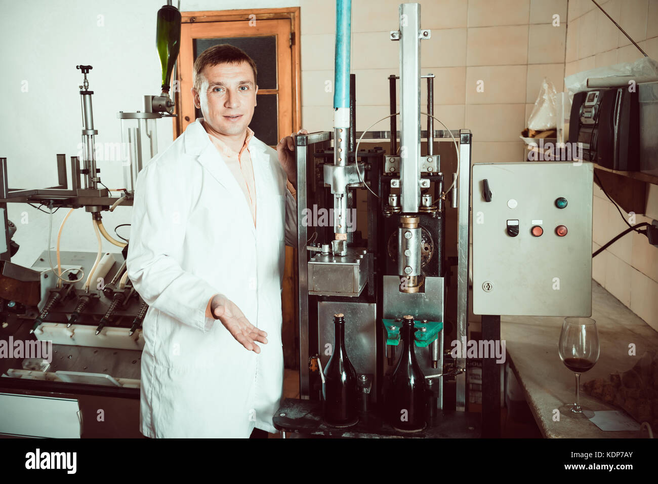 Male assembly line operator working in modern wine factory Stock Photo ...