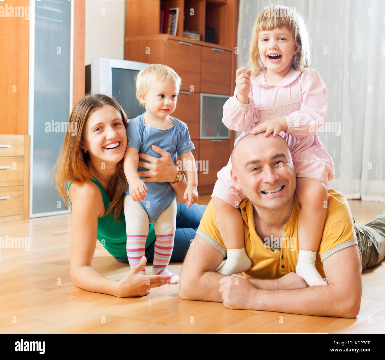 Portrait of a happy normal family of four with two children on the ...