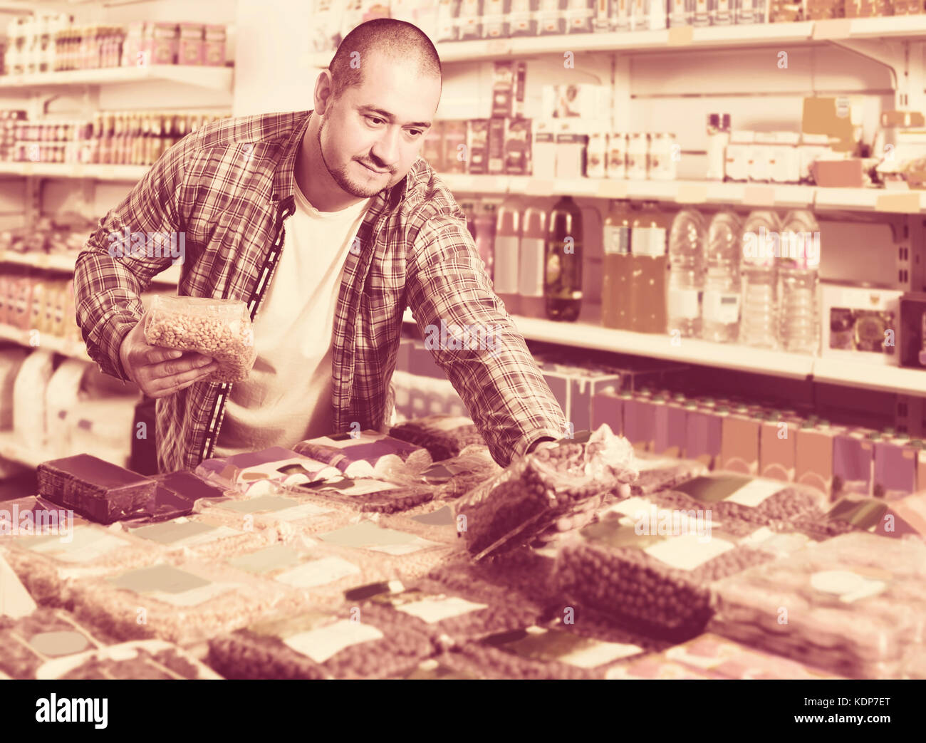 happy european male customer choosing nuts and grain in average food ...