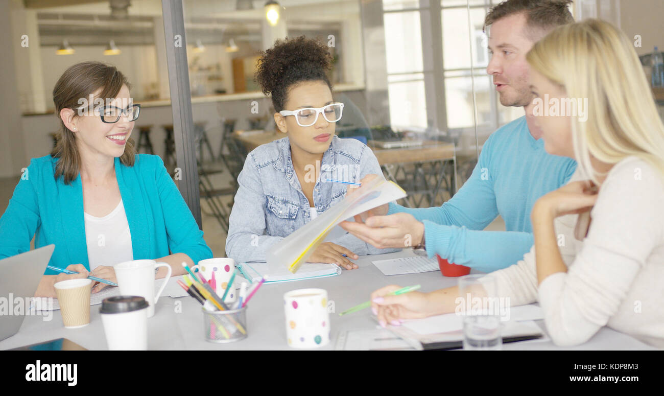 Man sharing documents with coworkers Stock Photo - Alamy