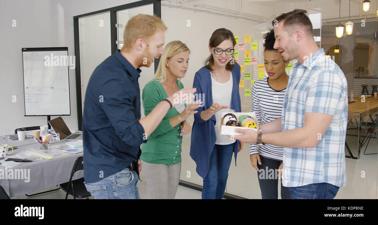Man sharing with colleagues Stock Photo - Alamy