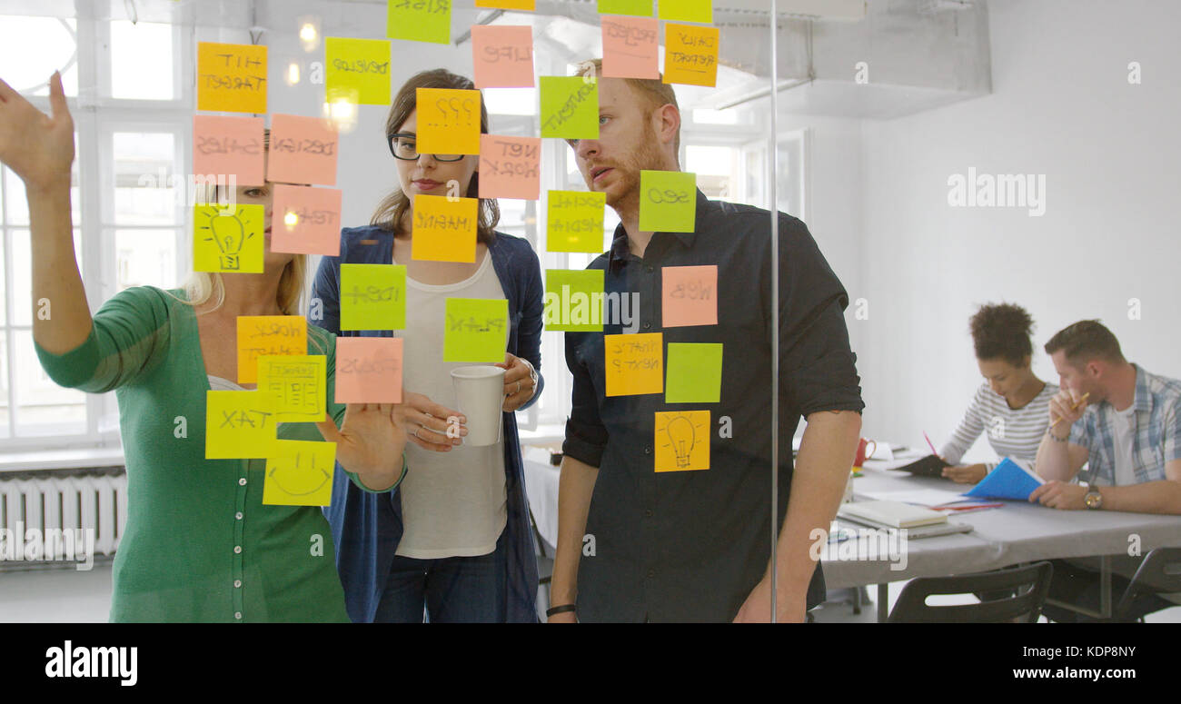 Stickers on wall and workers Stock Photo - Alamy