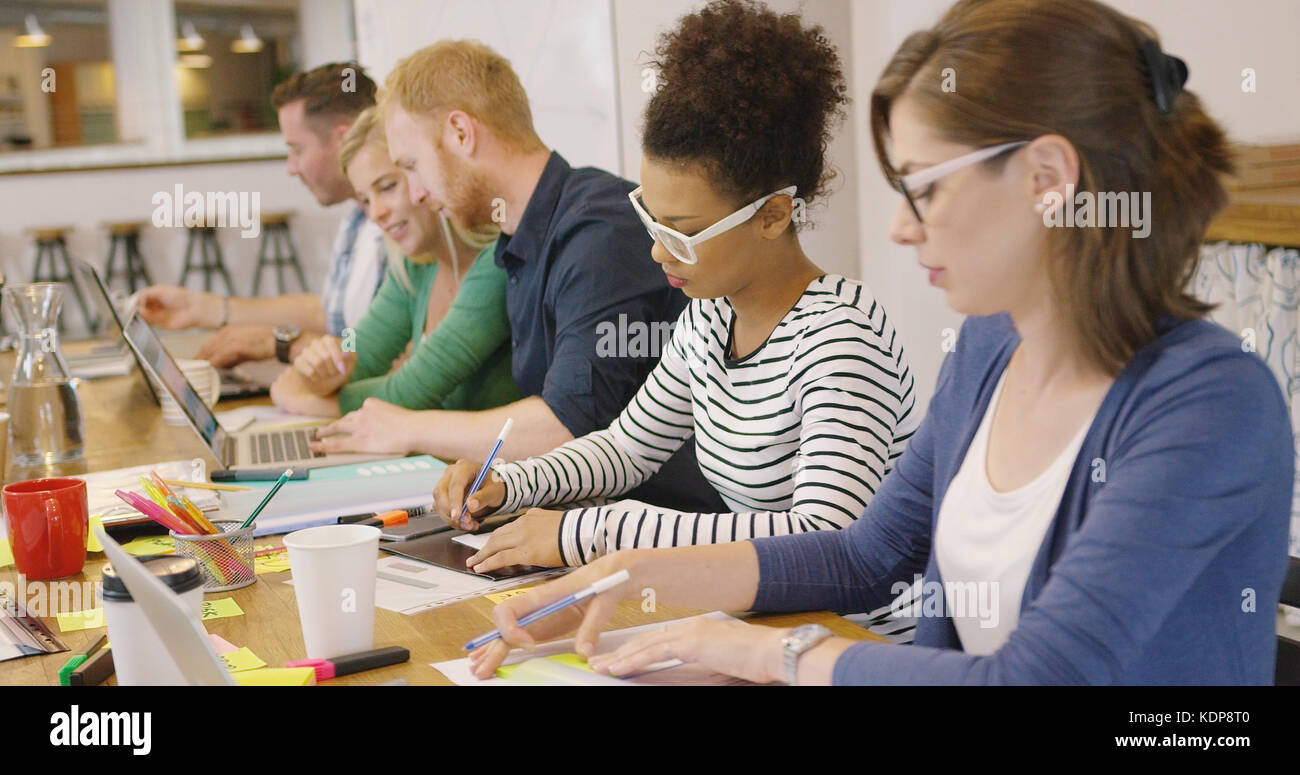 People working individually in office Stock Photo - Alamy