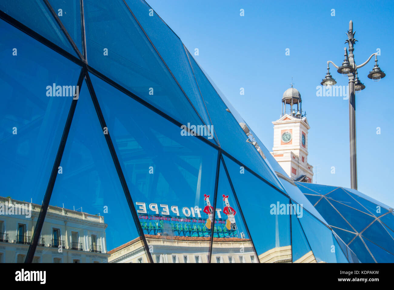 Tio Pepe neon sign reflected on glass facade of Cercanias station ...
