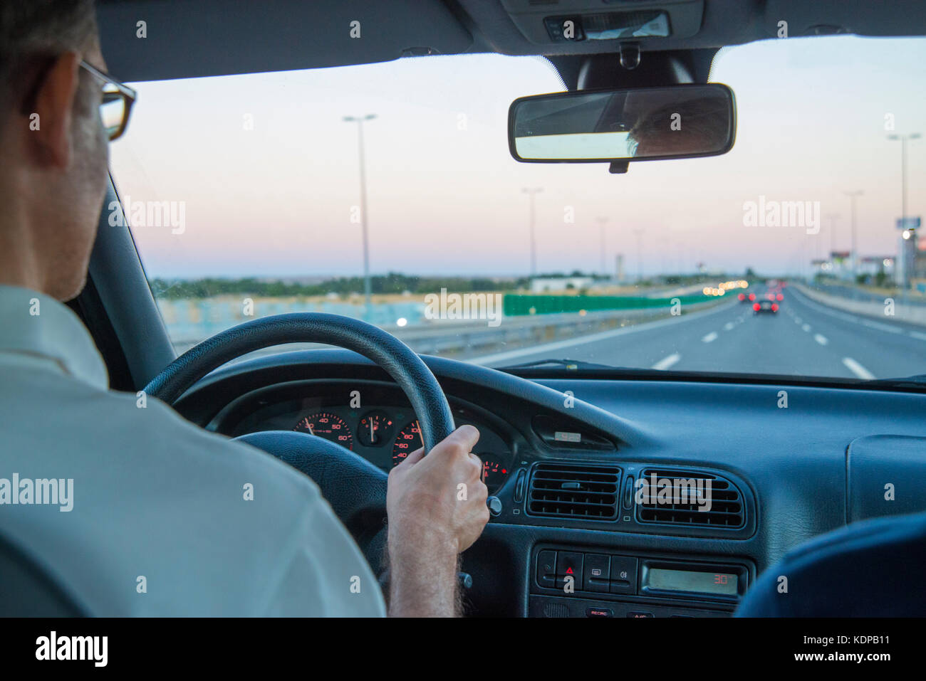 Man driving his car along the highway Stock Photo - Alamy