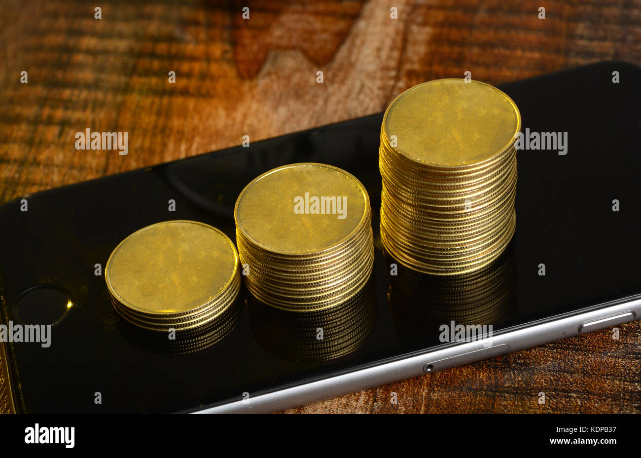 Stack of Coins going up graph on mobile screen Stock Photo - Alamy