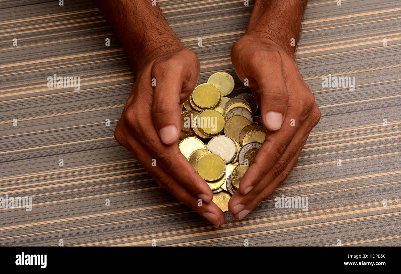 Hands around the pile of golden coins - currency concept Stock Photo ...