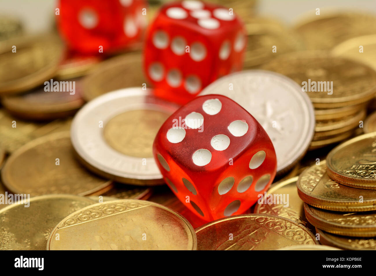 Pile of Golden Coins with Red dice Stock Photo - Alamy