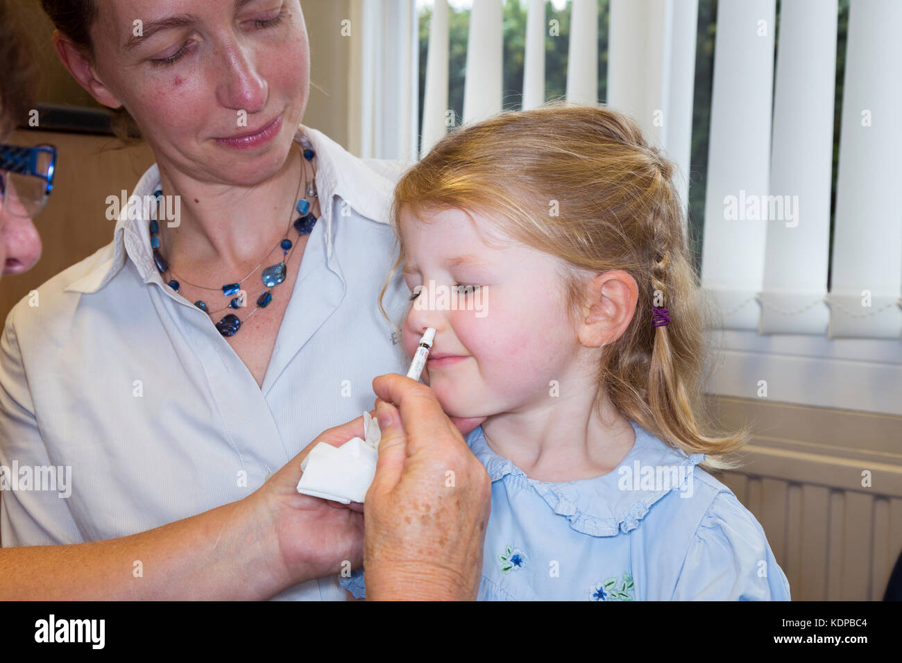3 year old child, with her mum / mother, receives dose of Fluenz flu ...