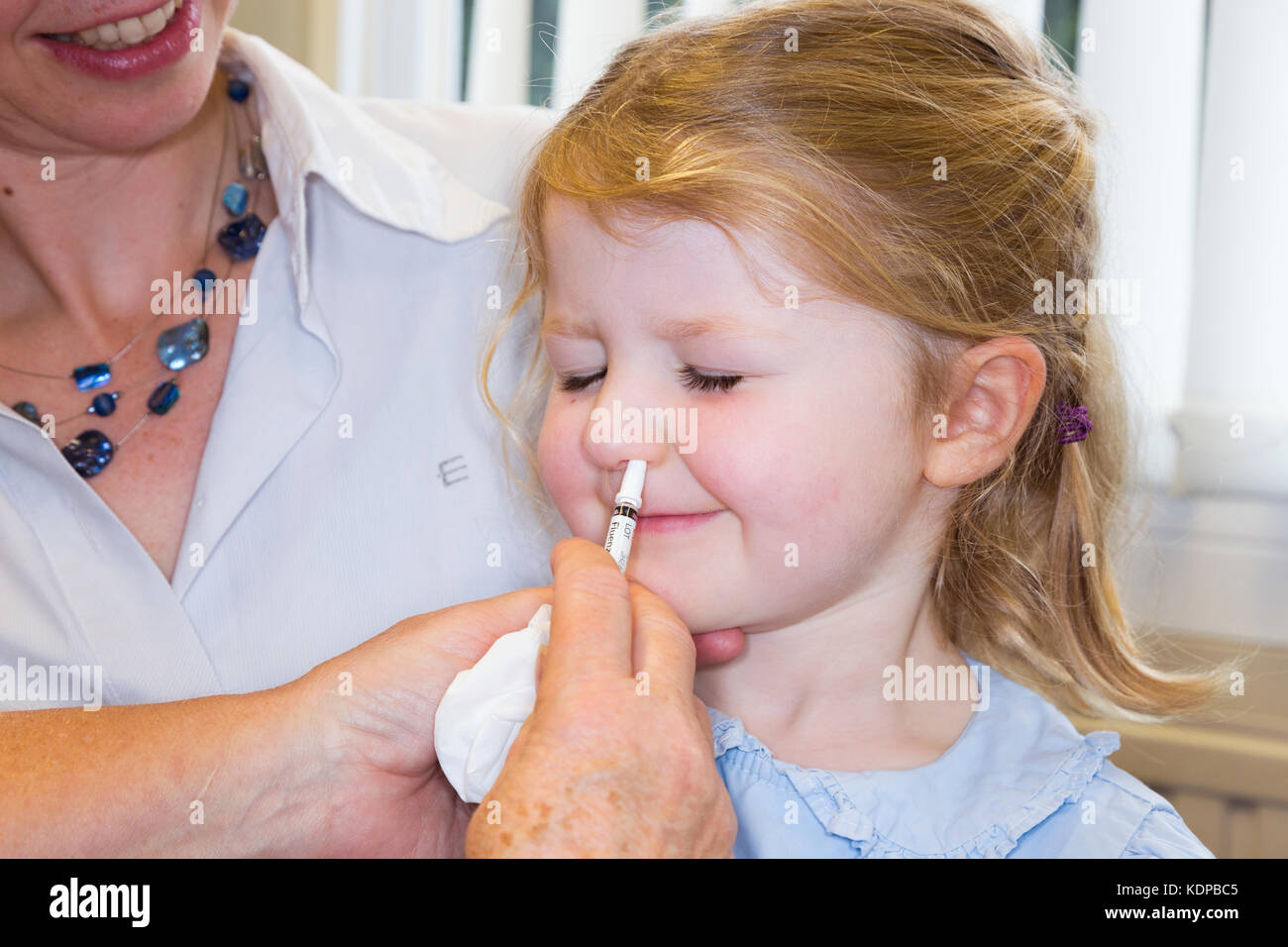 3 year old child, with her mum / mother, receives dose of Fluenz flu ...