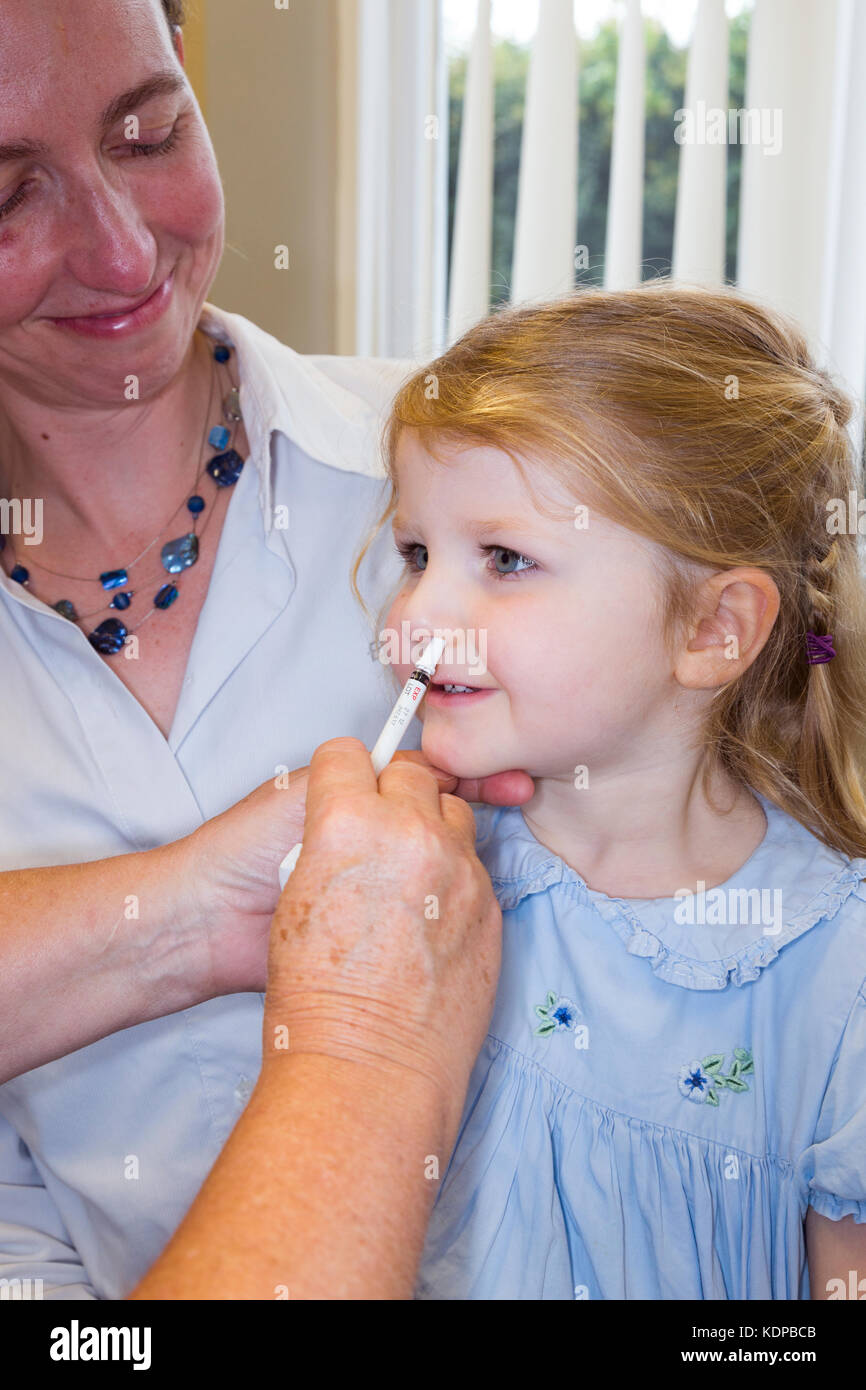 3 year old child, with her mum / mother, receives dose of Fluenz flu ...