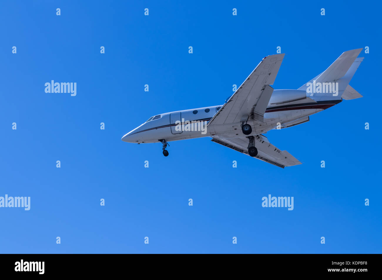 Bizjet on final approach against a clear blue sky Stock Photo - Alamy