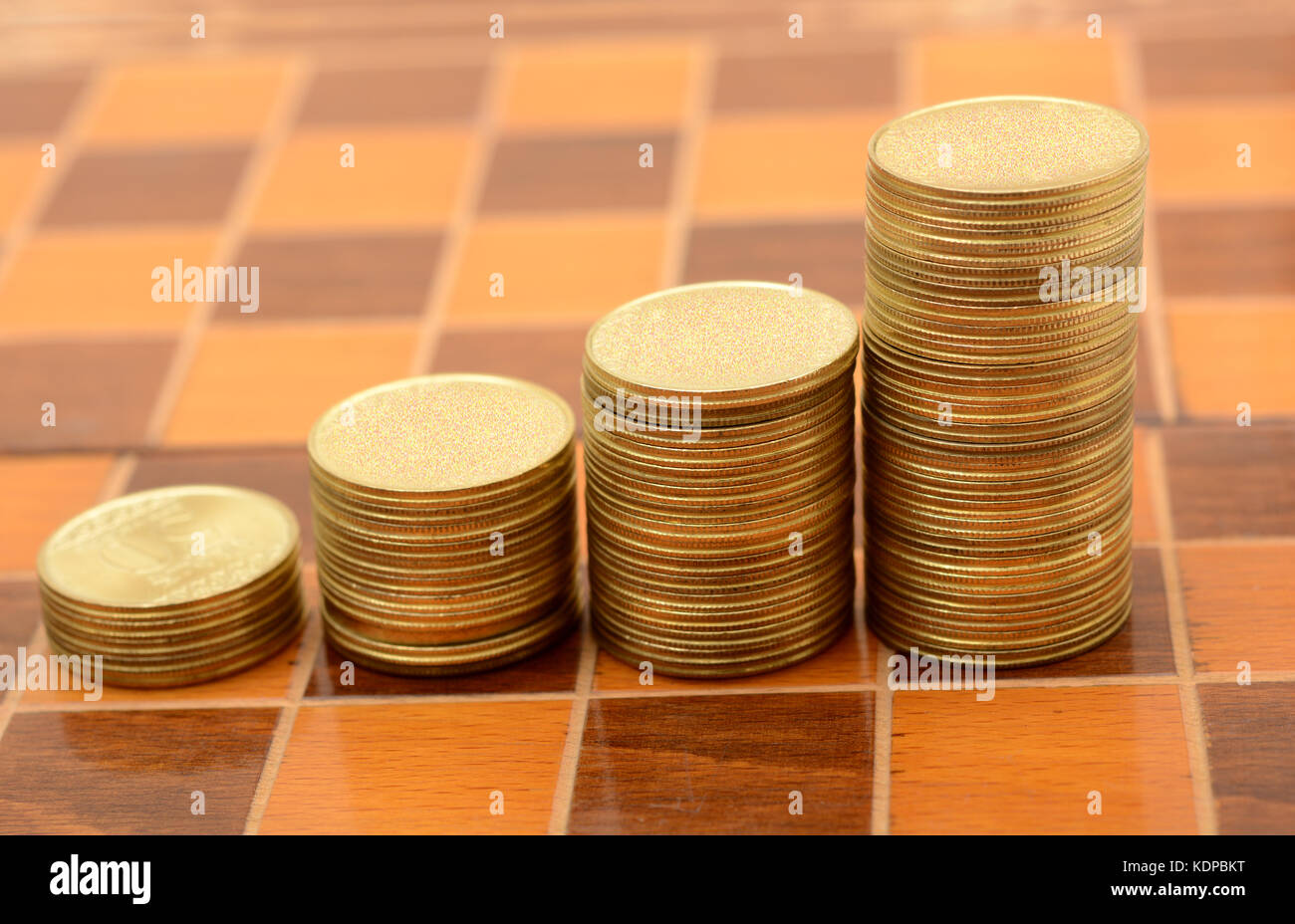 Stack of Coins making Growth graph on chess board Stock Photo - Alamy