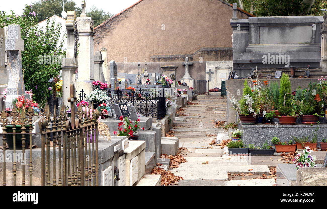 Traditional French cemetery with many crosses, flowers and ...
