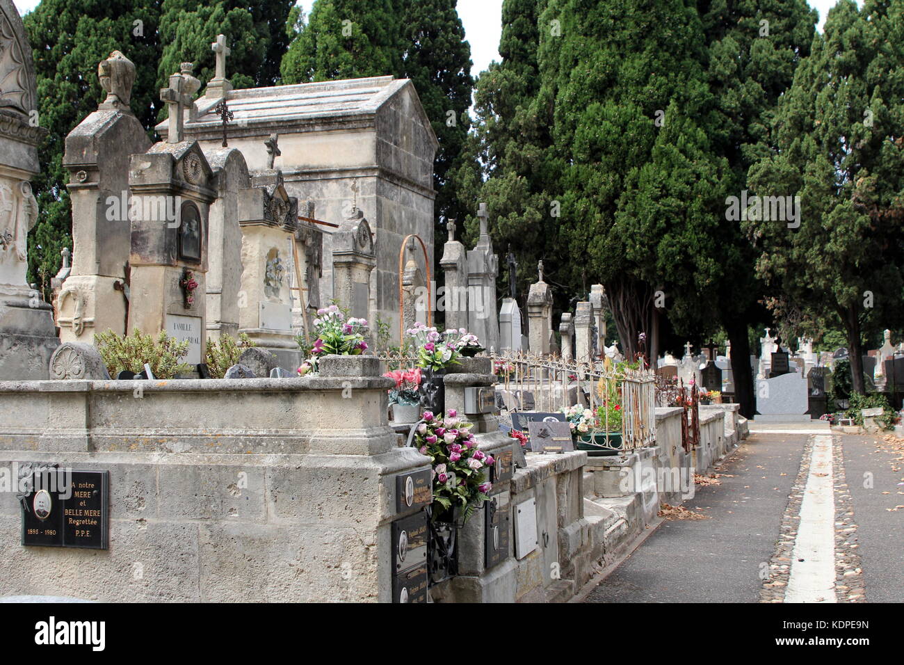 Traditional French cemetery with many crosses, flowers and ...