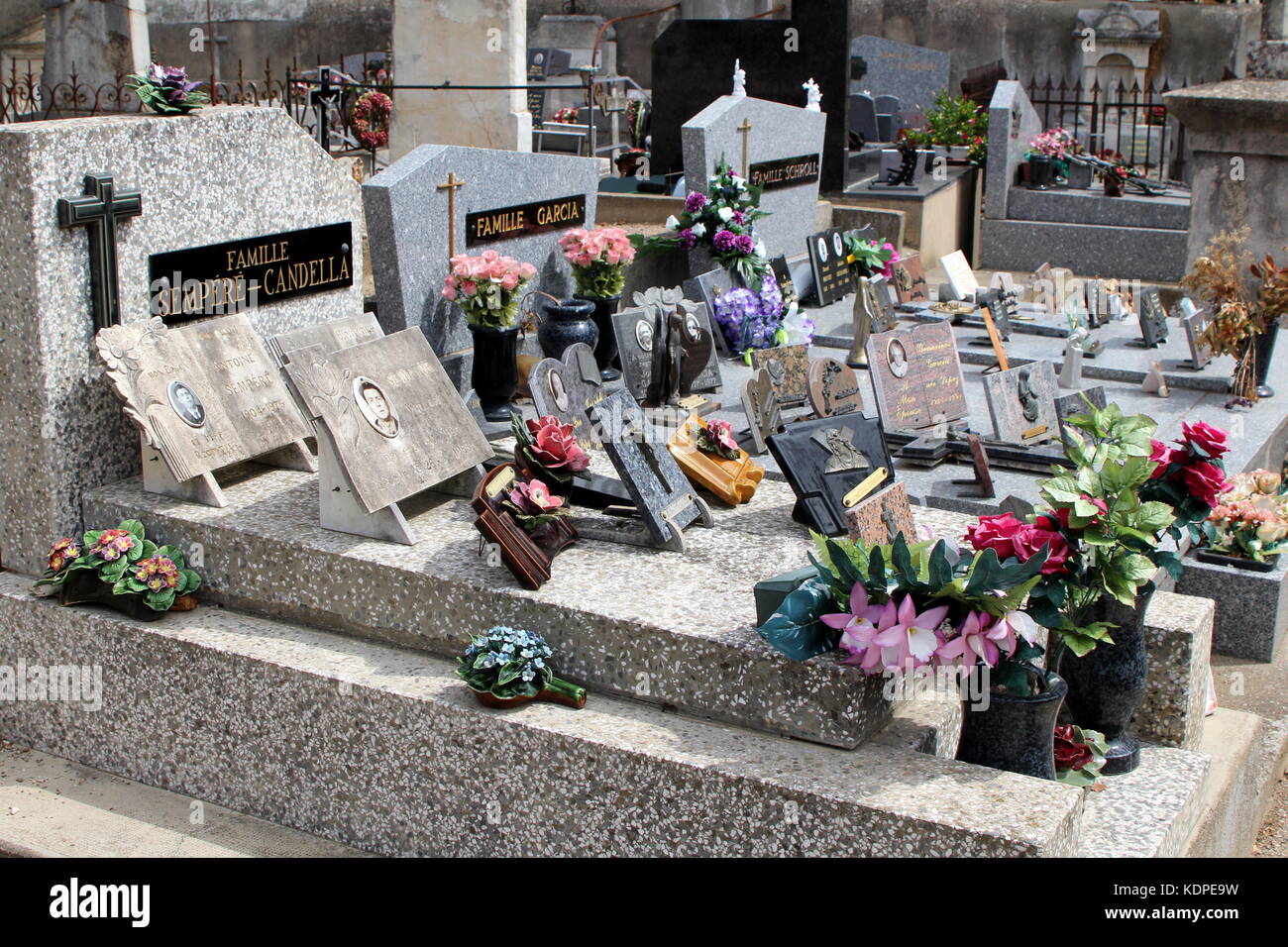 Traditional French cemetery with many crosses, flowers and ...