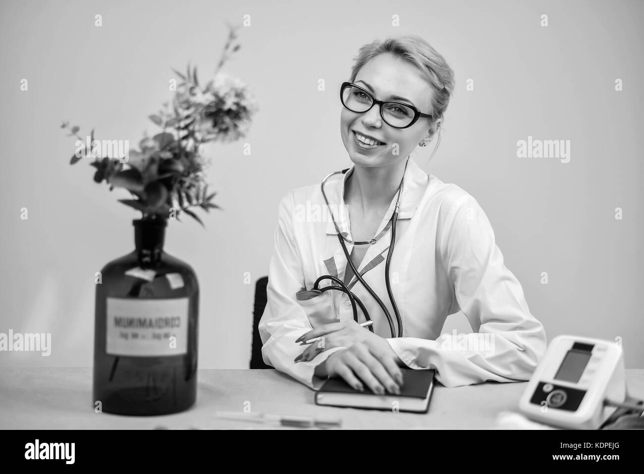 The doctor sitting behind the Desk Stock Photo - Alamy