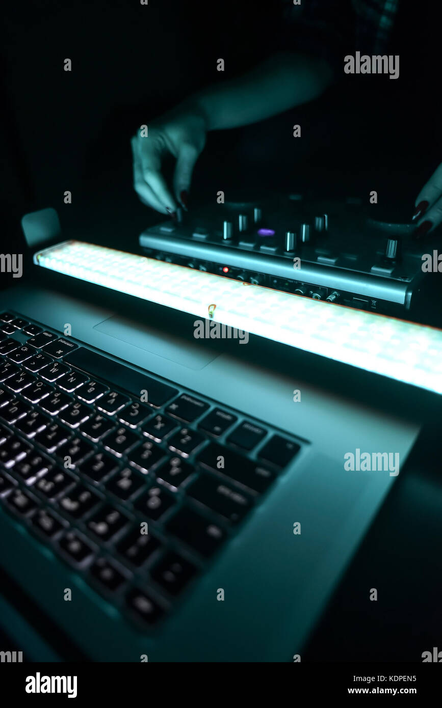 DJ mixer disco illuminated by searchlights Stock Photo - Alamy