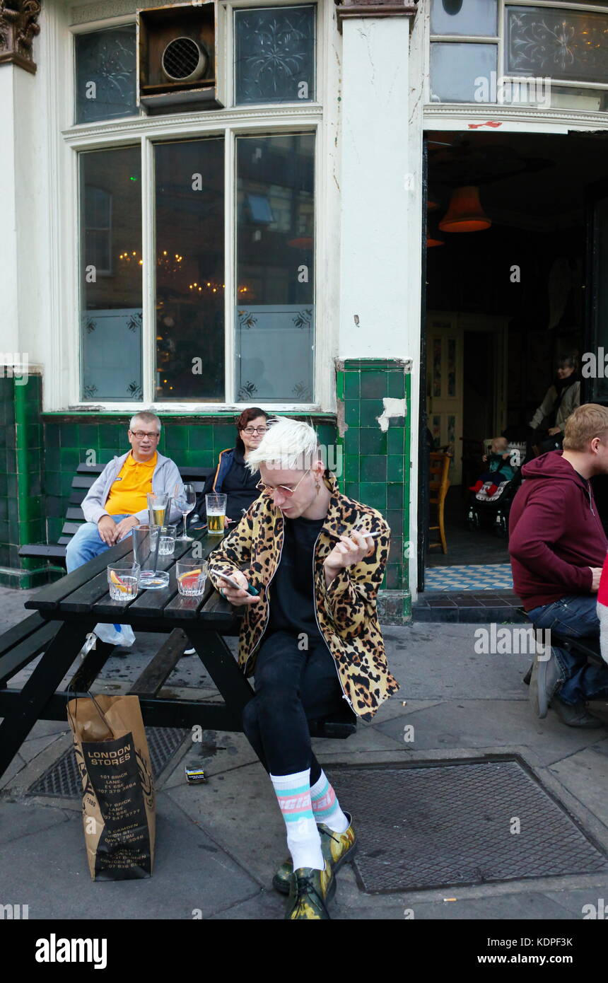 People seated at benches at the Commercial Tavern pub in London Stock ...