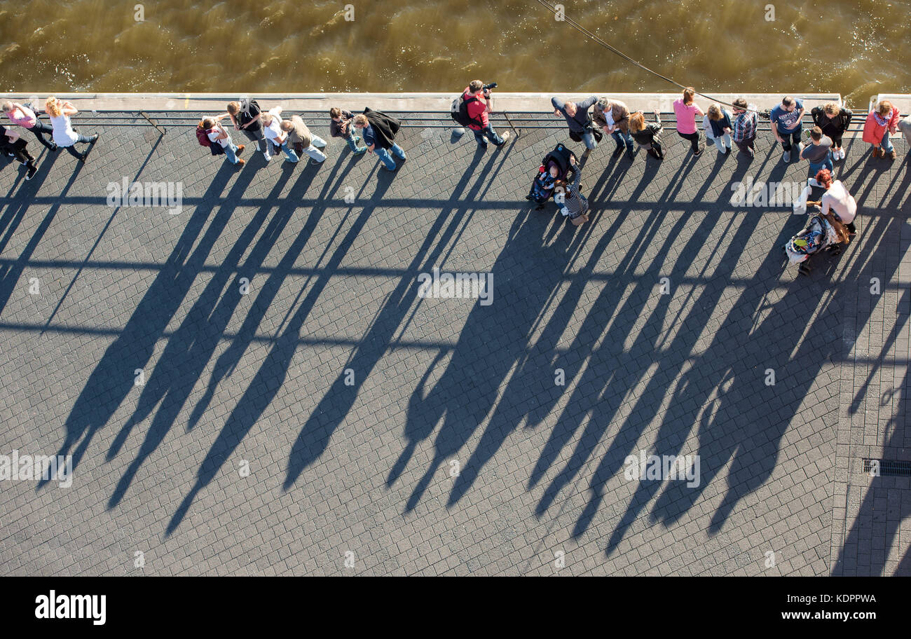 People cast long shadows at HafenCity in Hamburg, Germany, 15 October ...
