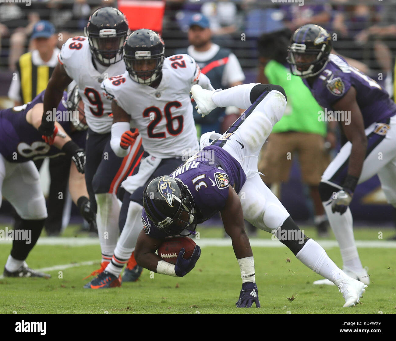 Baltimore Ravens RB Bobby Rainey (31) is tripped up before recovering ...