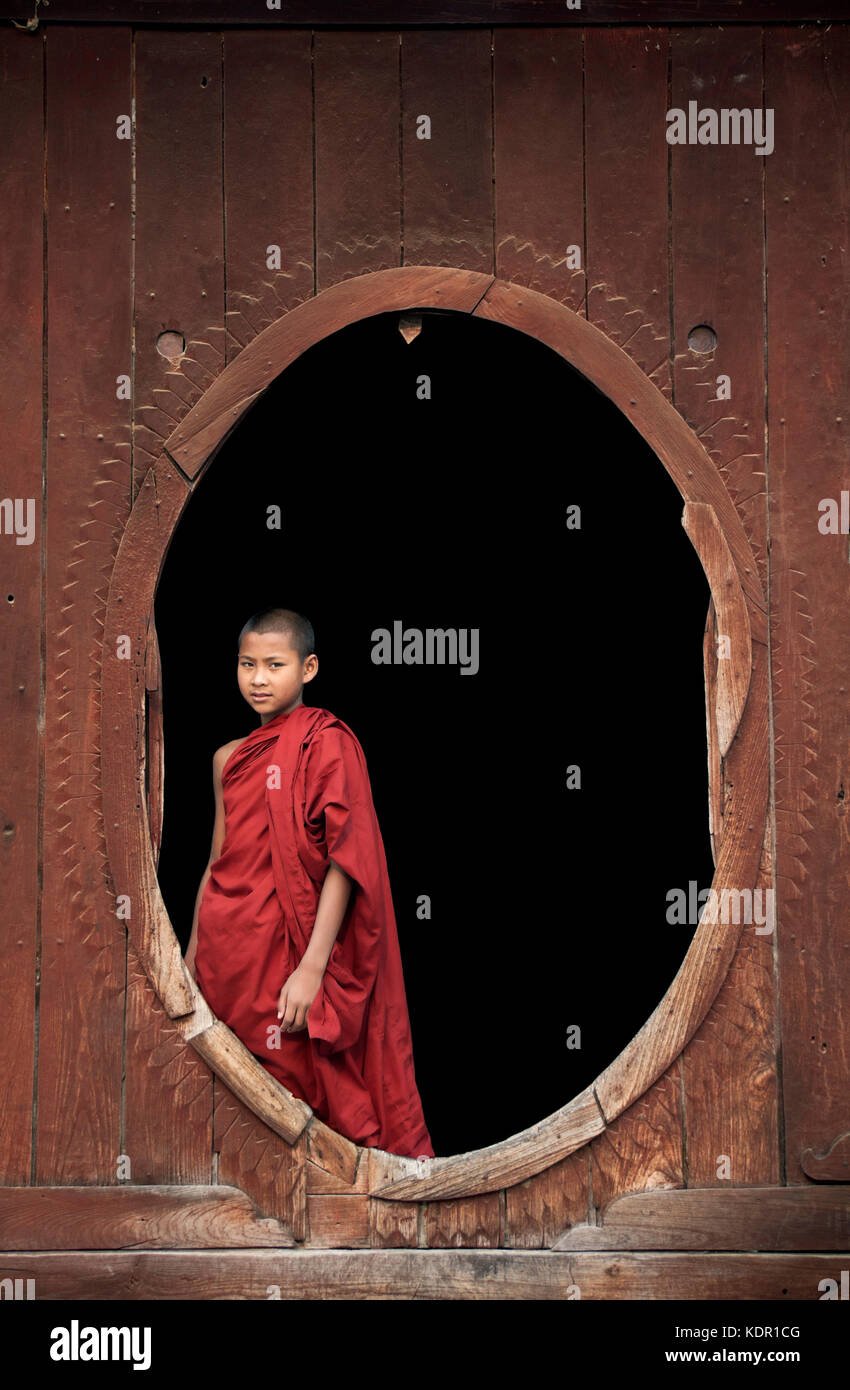 Myanmar, young novice Buddhist monks dressed in robes standing in ...