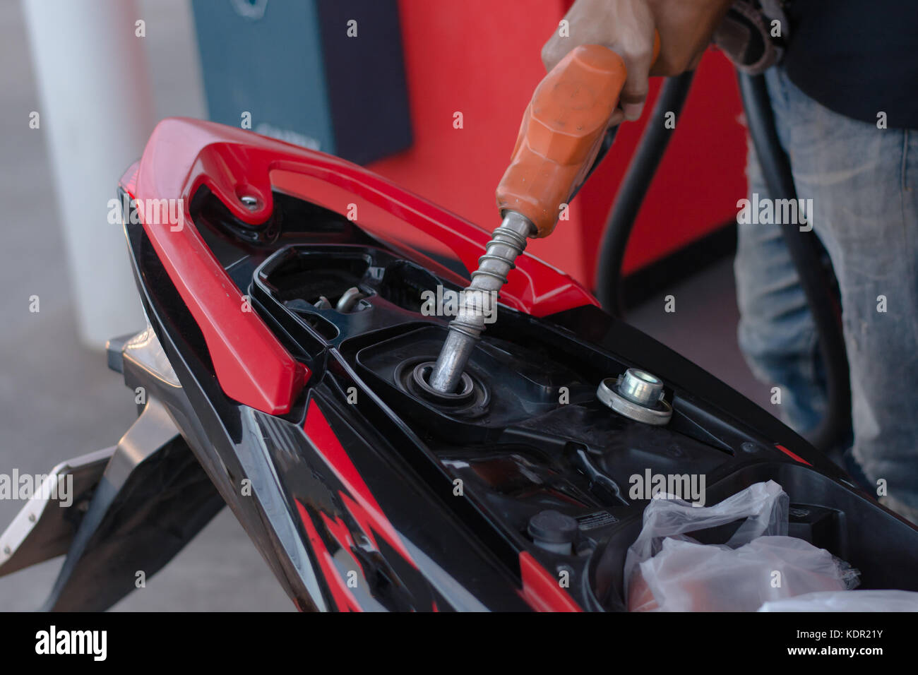 hand fuel nozzle in pouring to motorcycle at gas station Stock Photo ...