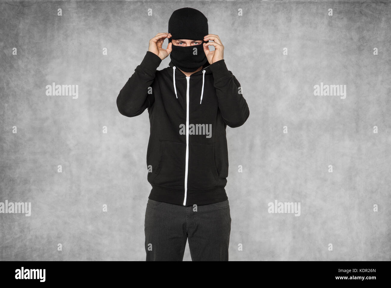 A masked man covers his face Stock Photo - Alamy