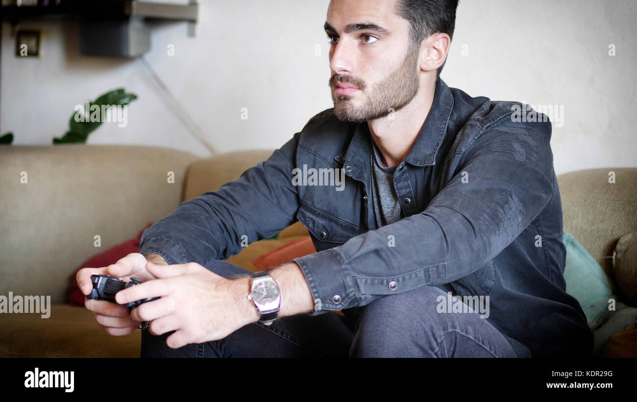 Young man using joystick or joypad for videogames Stock Photo - Alamy