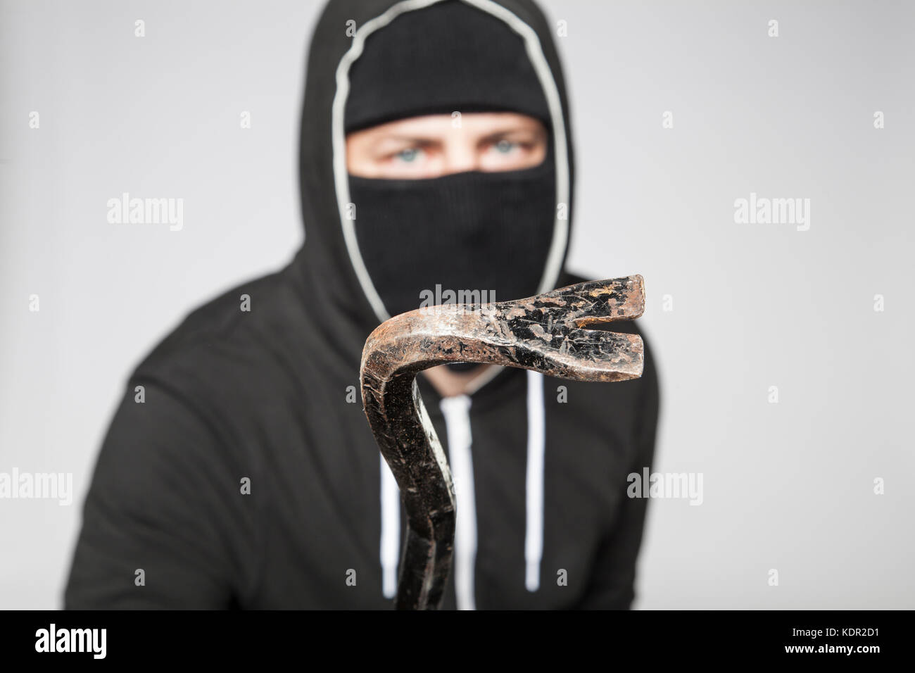thief with a crowbar in his hand Stock Photo - Alamy
