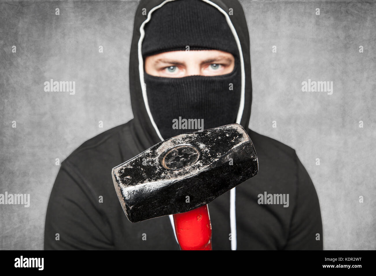 masked stranger shows a hammer to the camera Stock Photo - Alamy