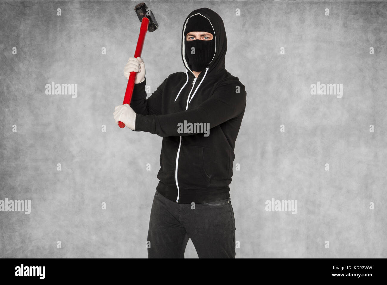 A masked stranger takes an attack with large hammer Stock Photo - Alamy
