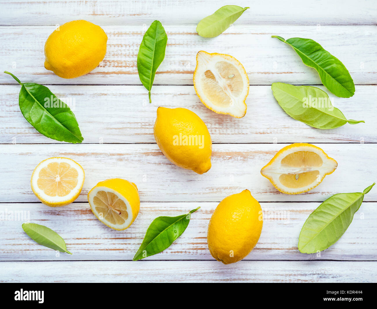 Fresh lemons and lemons leaves on rustic wooden background. Fresh ...