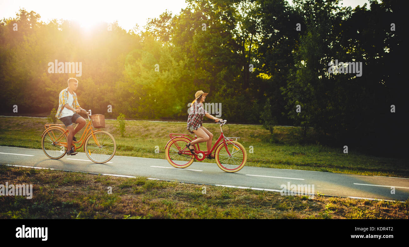 Love couple riding on vintage bicycles in summer park, romantic date of ...
